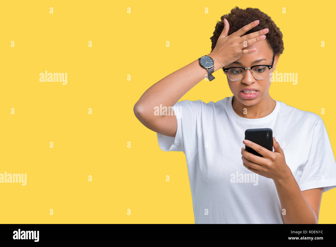 Young african american woman using smartphone over isolated background ...