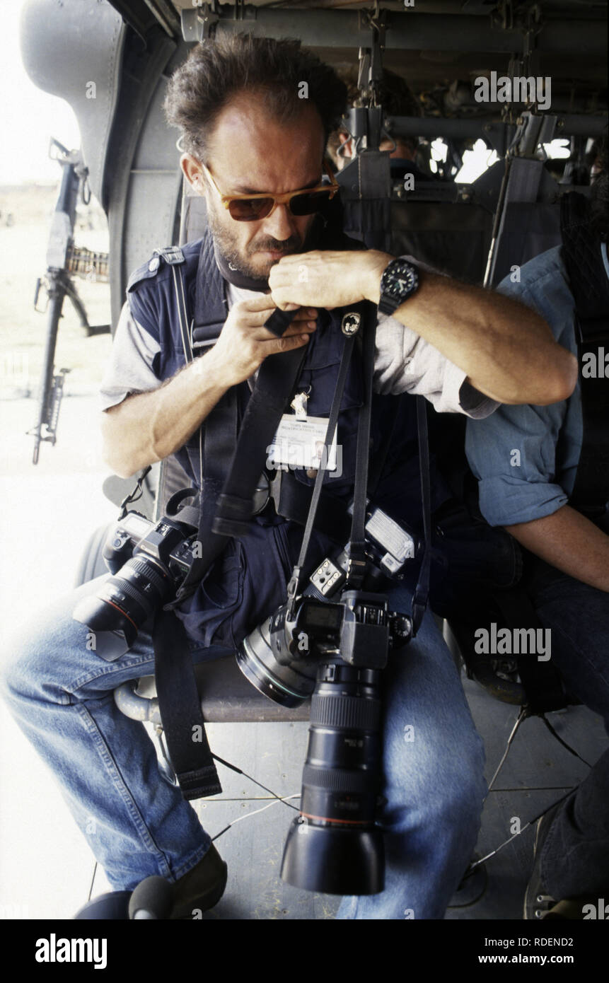 12th October A press photographer adjusts his safety harness on board a ...