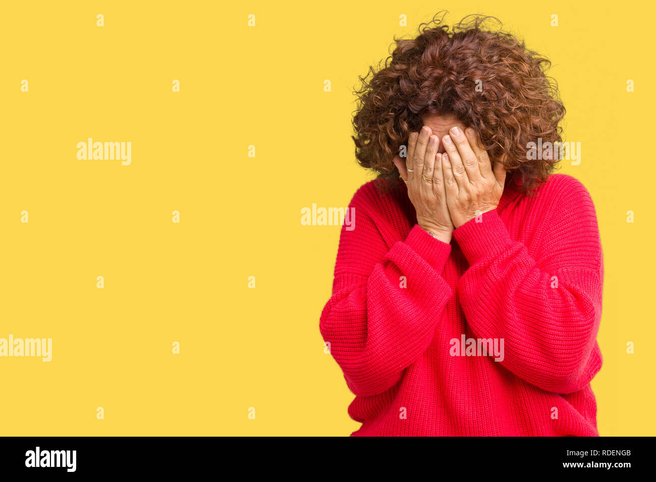 Beautiful middle ager senior woman red winter sweater over isolated ...