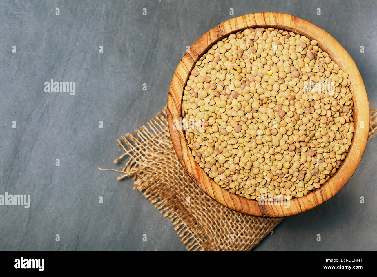 Raw lentils on balck stone background. Healthy vegetarian food concept ...