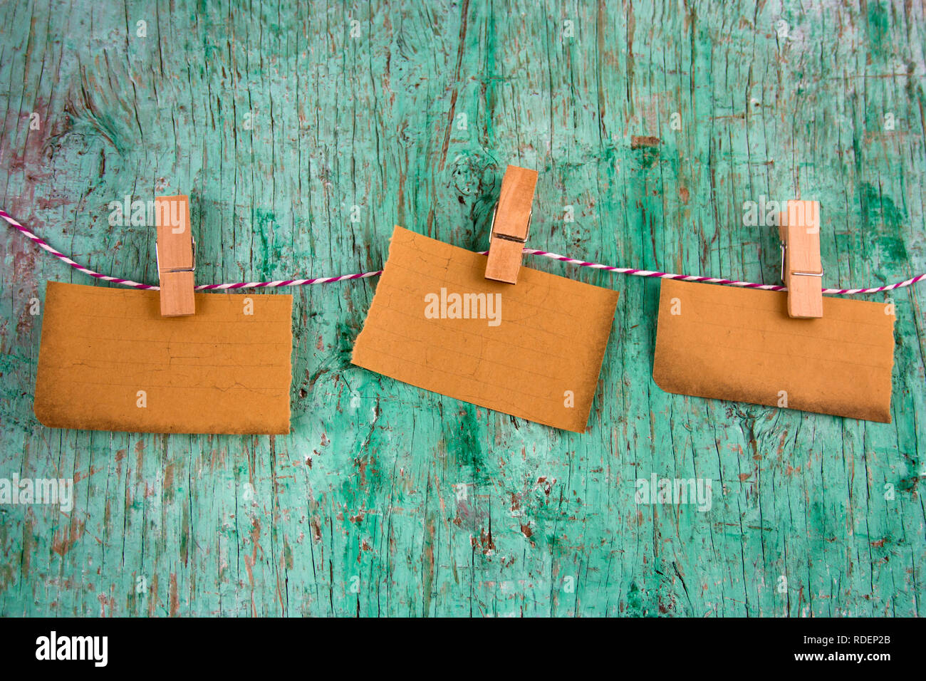 empty vintage paper notes and a clothes pegs on shabby mint green ...