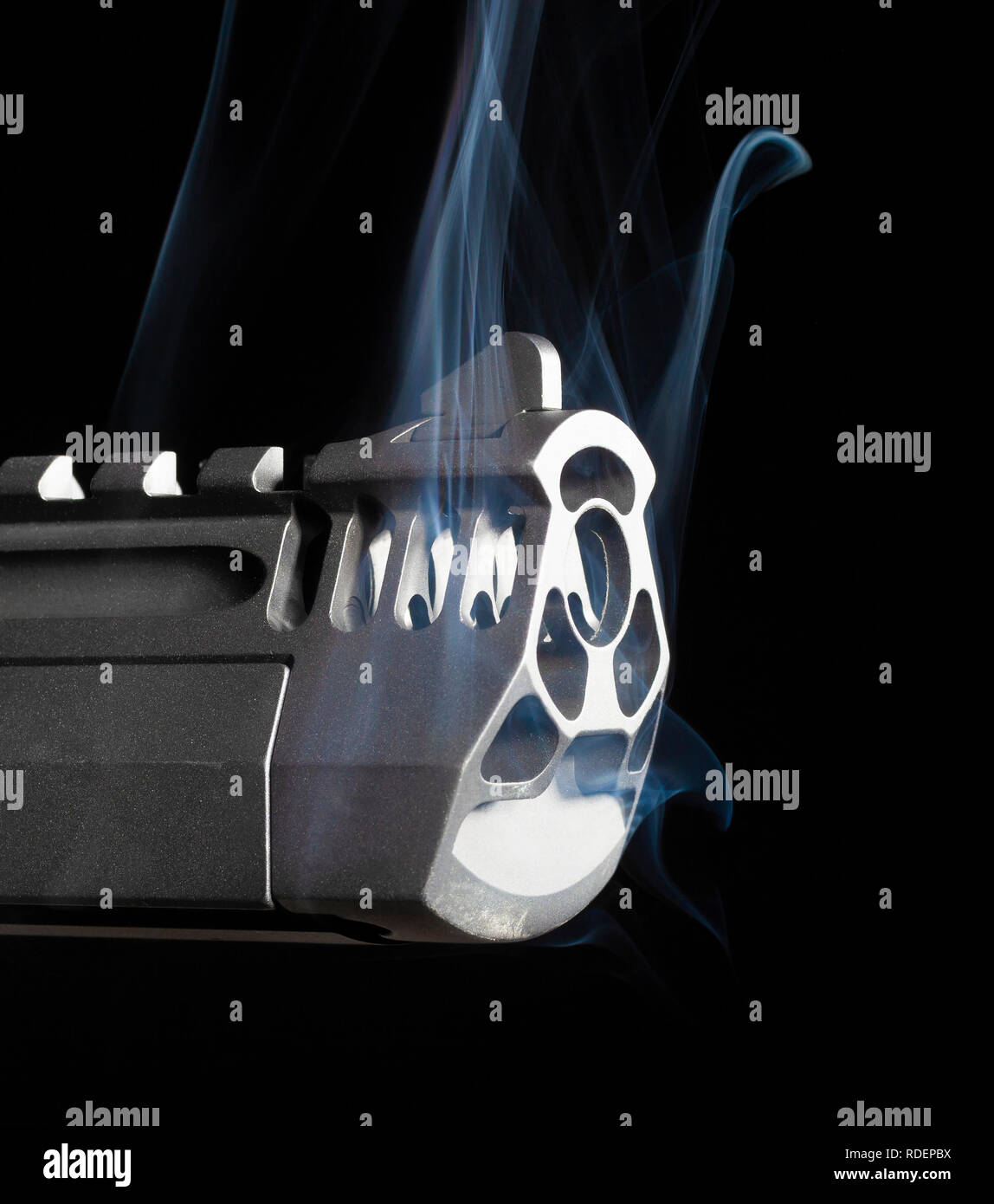 Smoke coming from a pistol on a black background Stock Photo - Alamy