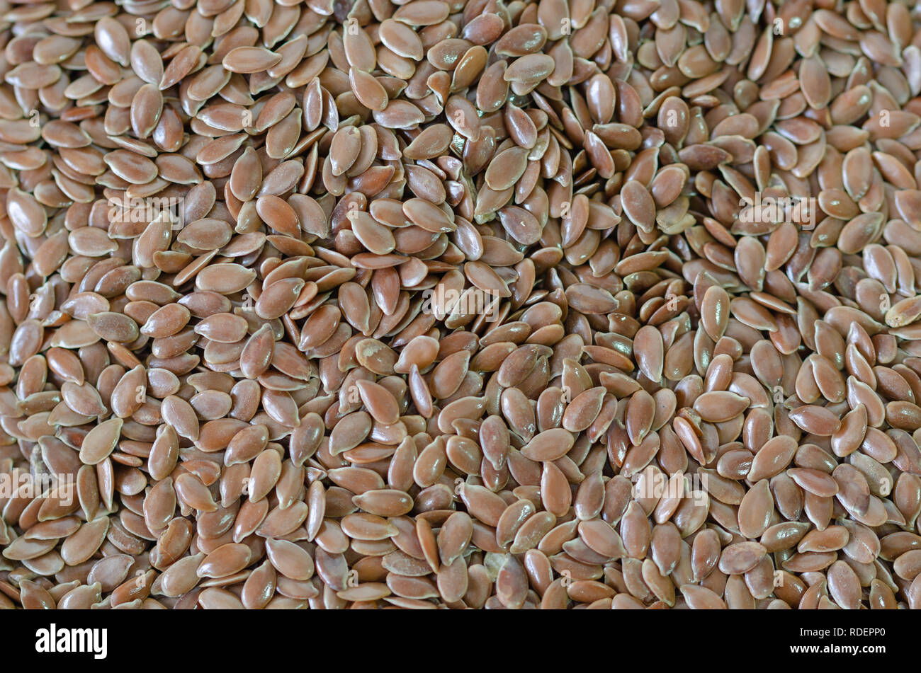 Brown flax seeds close-up top view. Background, texture Stock Photo - Alamy