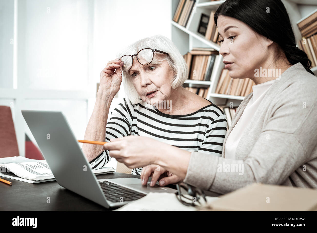 Concentrated female person staring at screen of computer Stock Photo ...