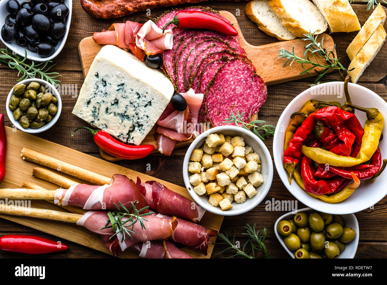 Traditional spanish tapas on table, food selection, cold meat, sausage ...
