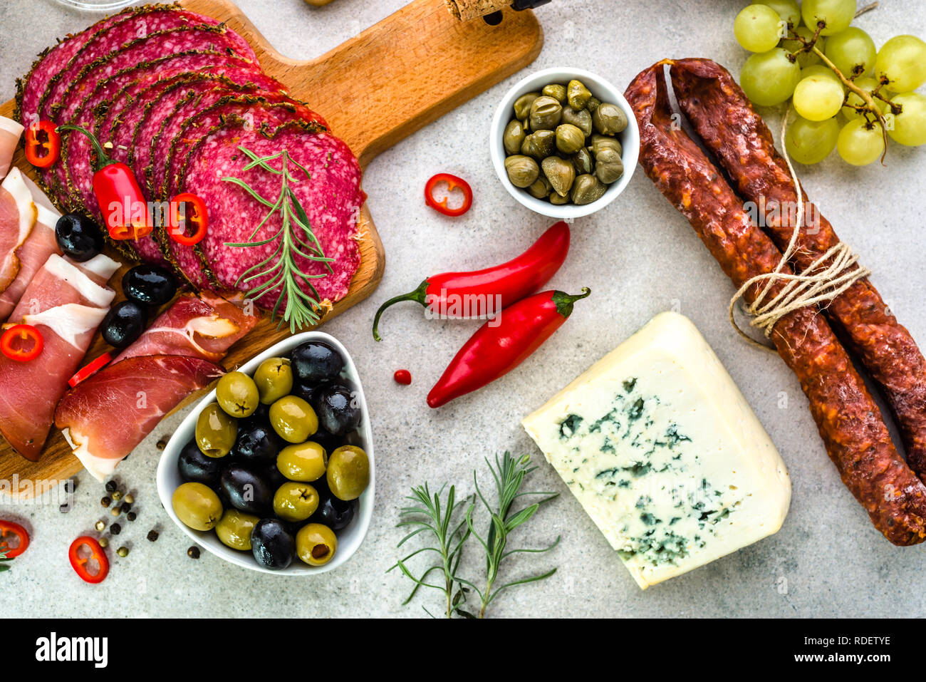 Spanish food on table with cold meat, spicy tapas, chorizo, salami ...