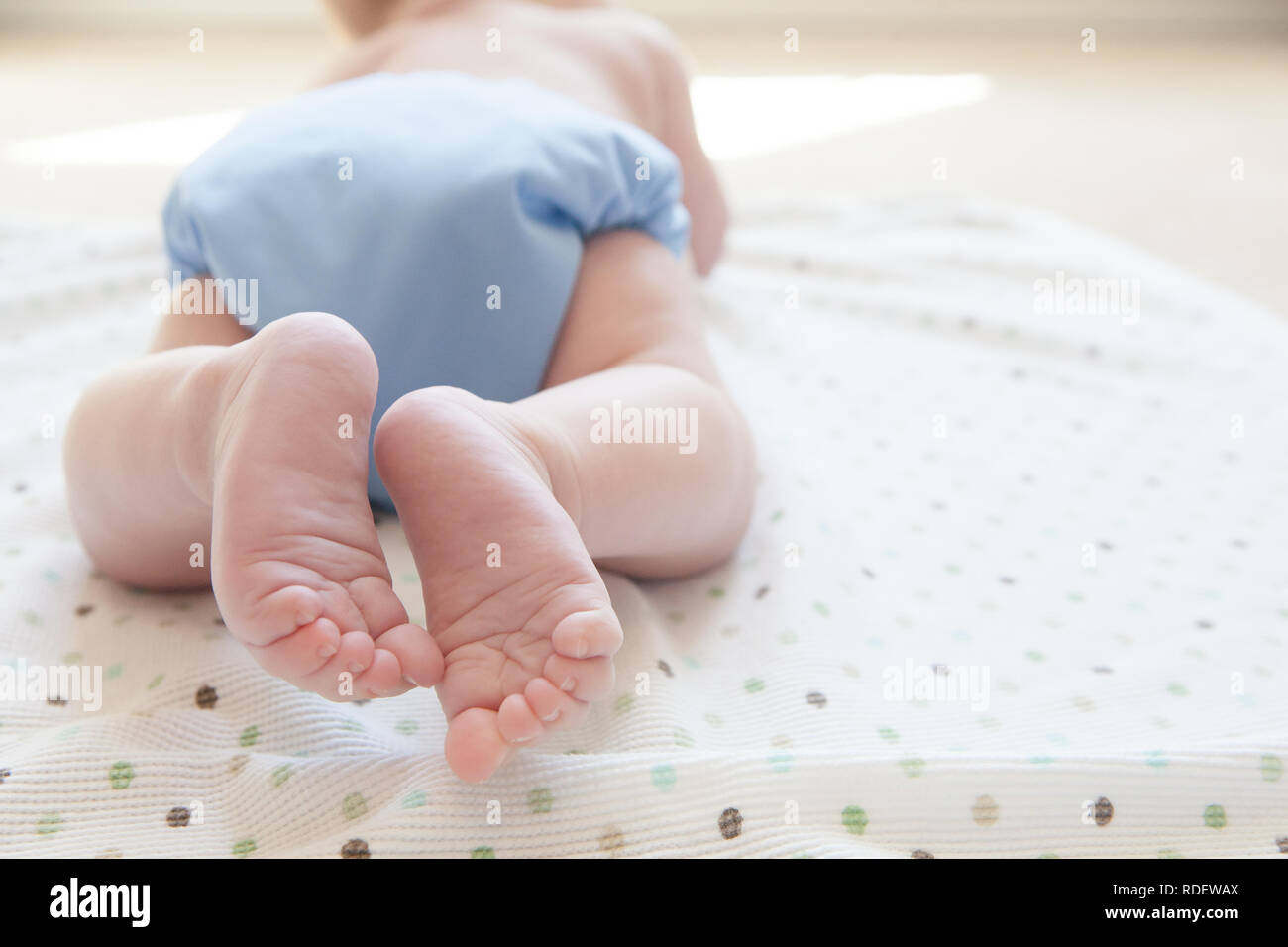 Crawling baby wearing blue cloth diaper Stock Photo - Alamy