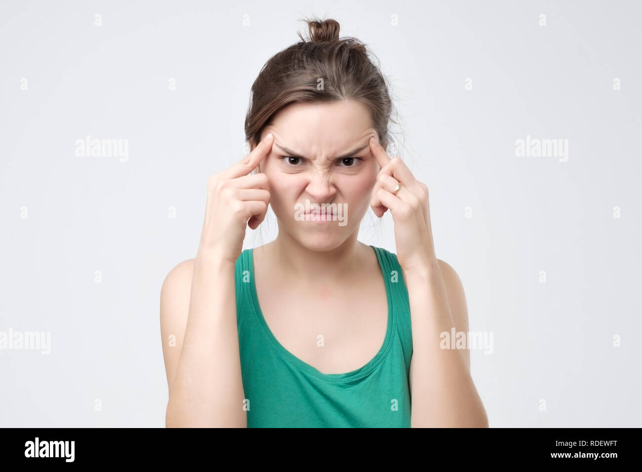 Pretty woman looking at camera with angry face Stock Photo - Alamy