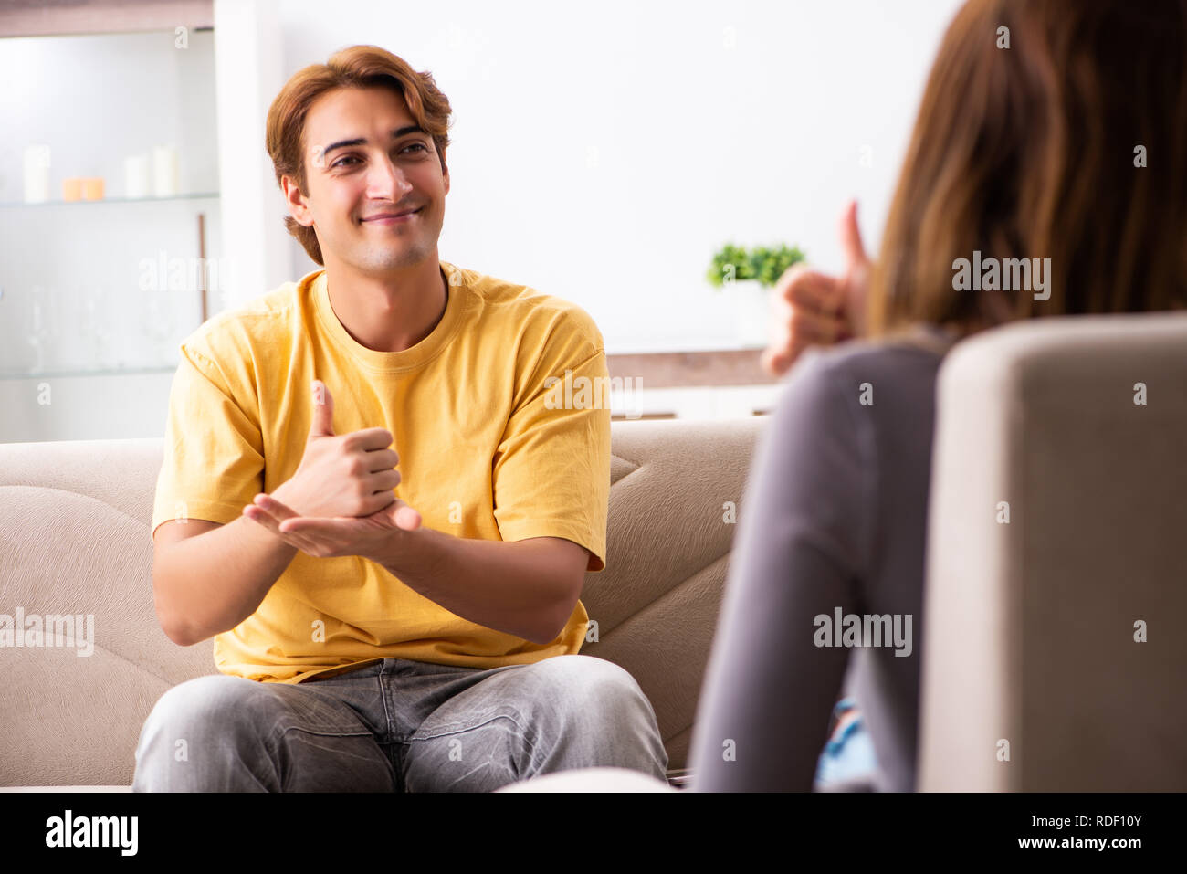 Woman and man learning sign language Stock Photo - Alamy