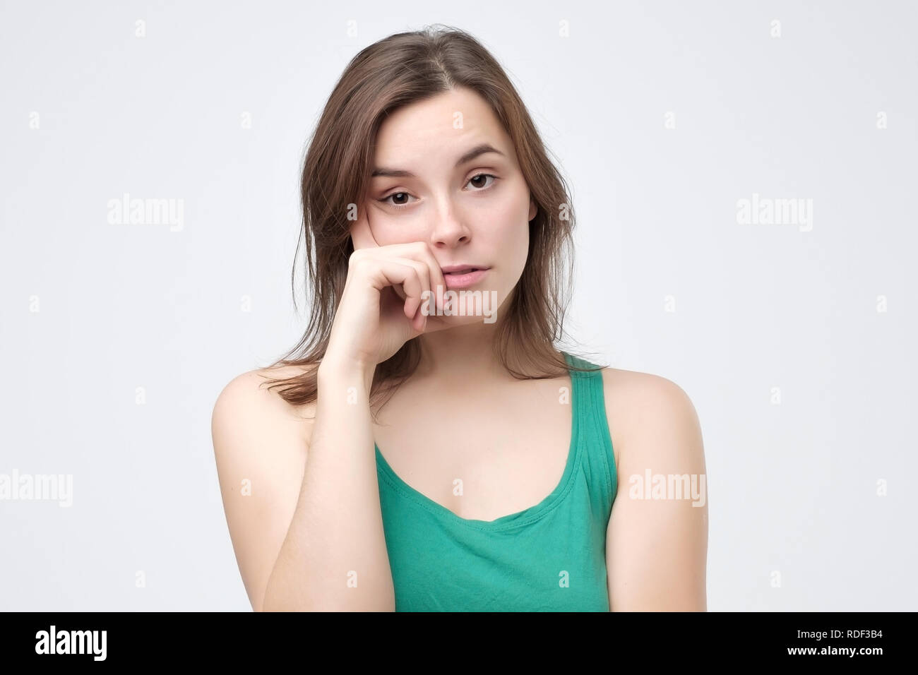 Pissed woman leaning on fist and gazing with careless expression Stock ...