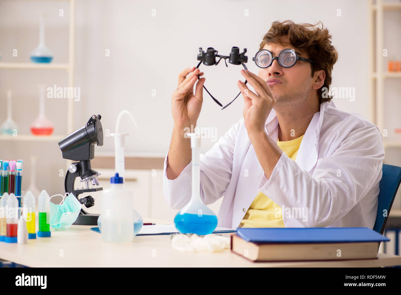 Funny crazy chemist doing experiments and tests Stock Photo - Alamy