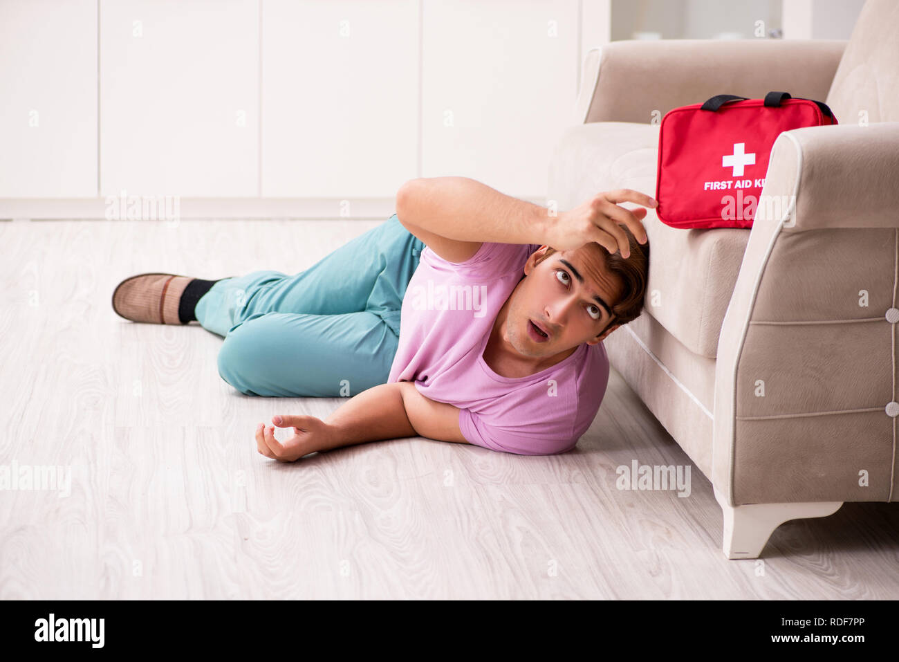 Sick man at home with first aid kit Stock Photo - Alamy
