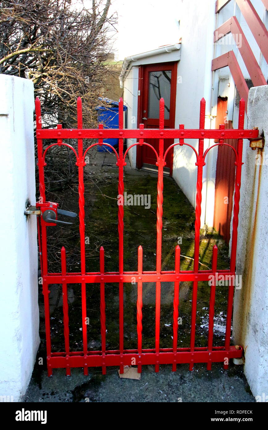 The red gate leads to the entrance of this house Stock Photo - Alamy