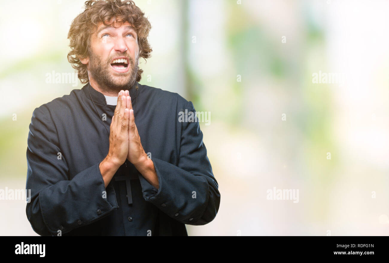 Handsome praying priest on hi-res stock photography and images - Alamy