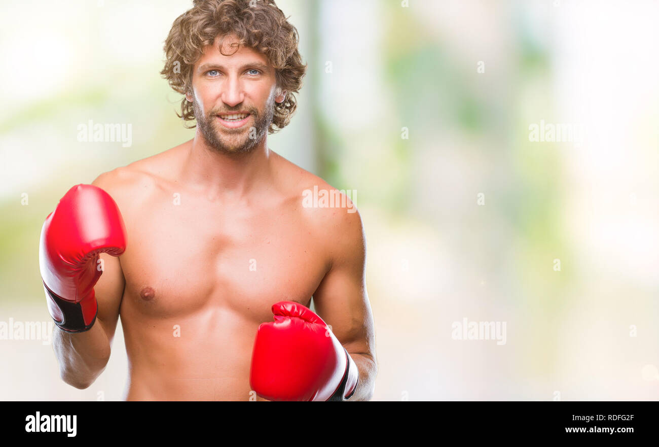 Handsome hispanic boxer man wearing boxing gloves over isolated ...