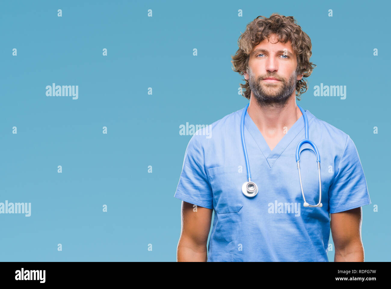 Handsome hispanic surgeon doctor man over isolated background with ...