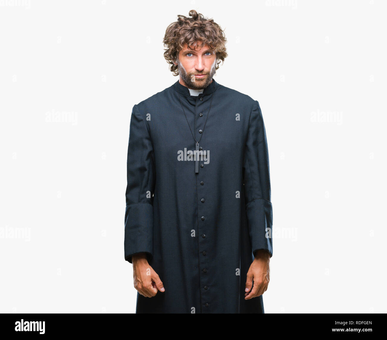 Handsome hispanic catholic priest man over isolated background ...