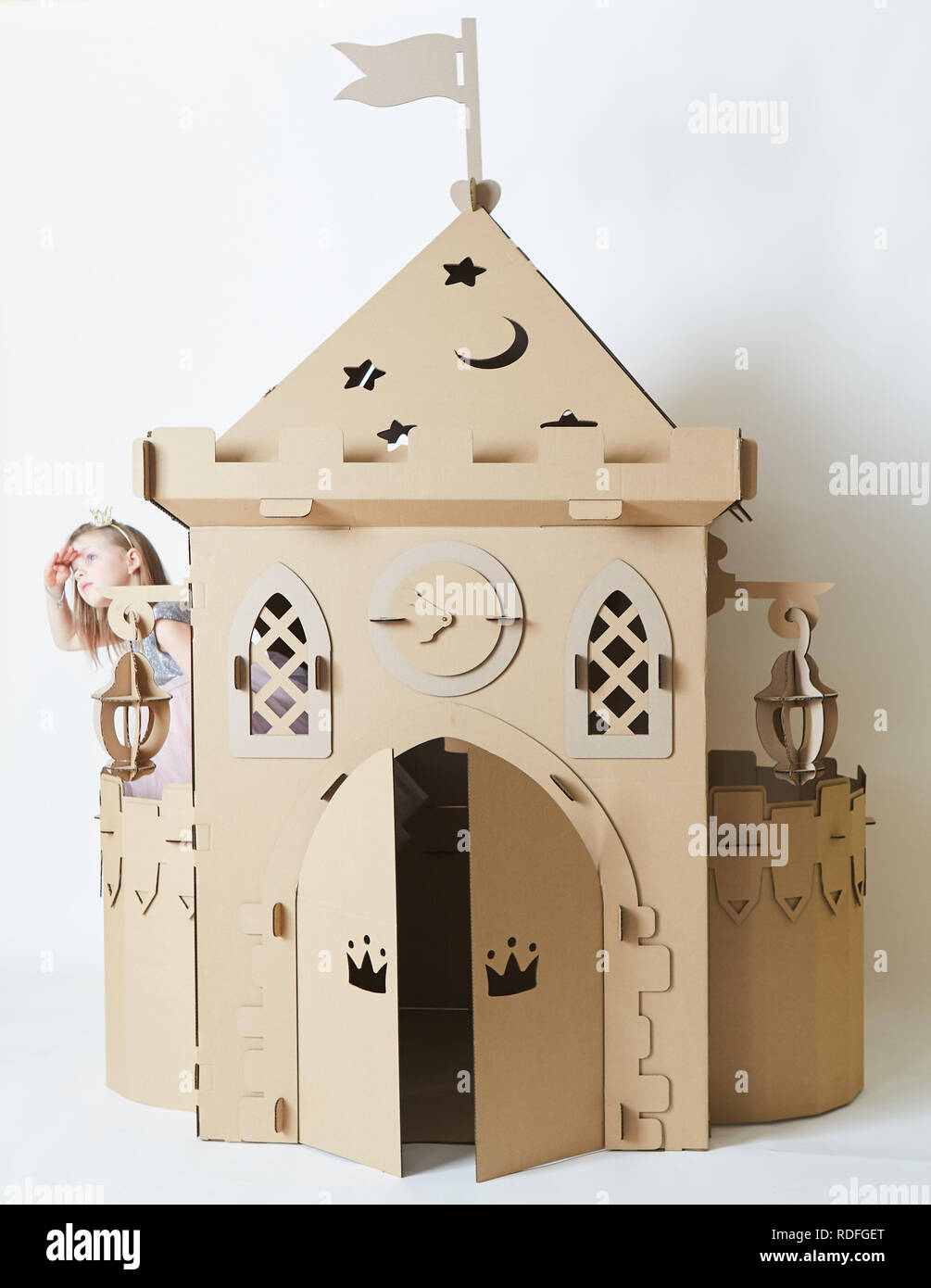 Beautiful little girl in princess dress playing with her toy castle ...