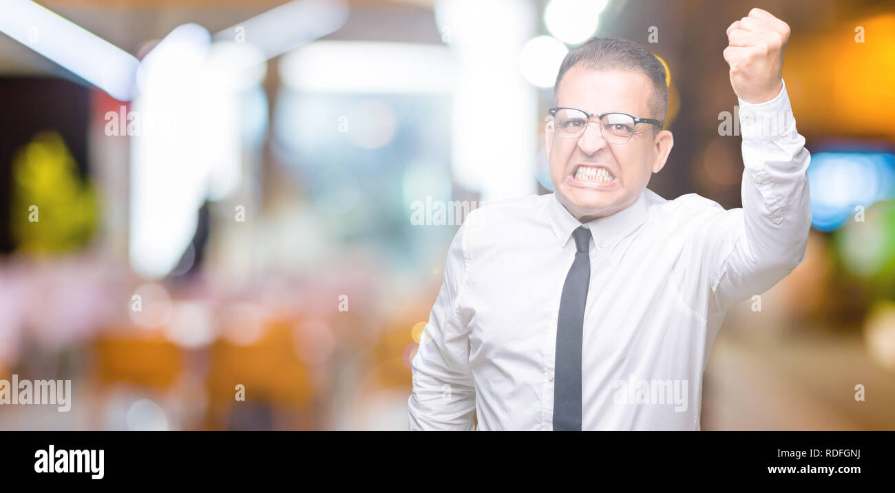 Middle age bussines arab man wearing glasses over isolated background ...