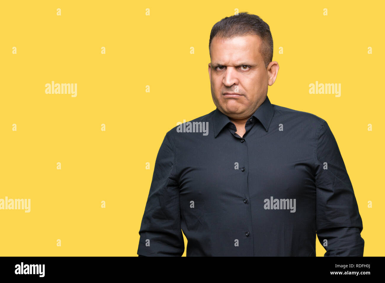 Handsome middle age arab business man over isolated background skeptic ...