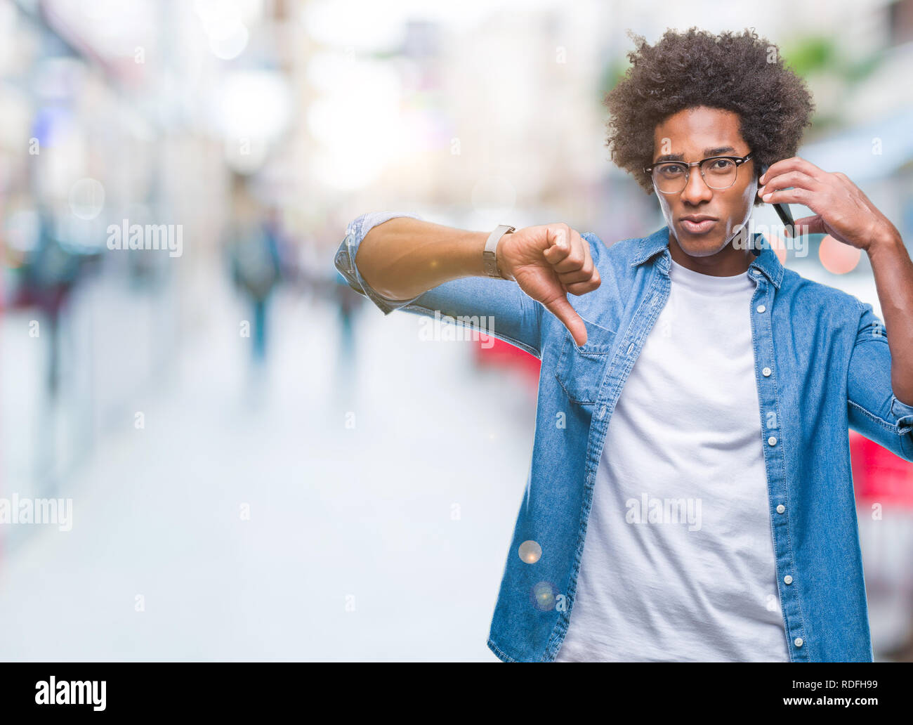 Afro american man talking on the phone over isolated background with ...