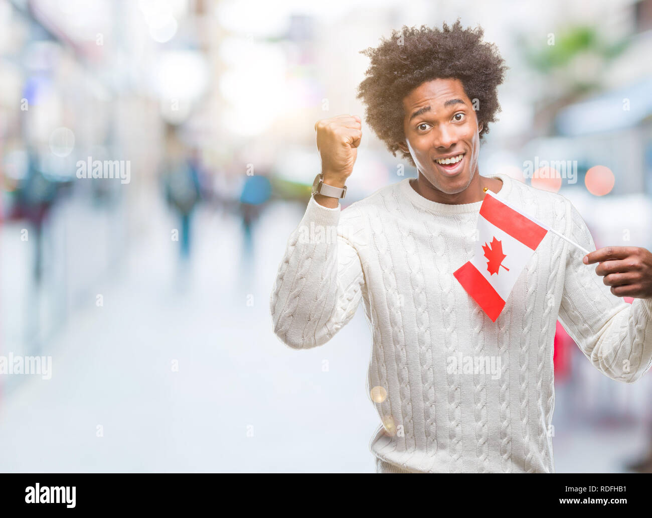 Afro american man flag of Canada over isolated background annoyed and ...