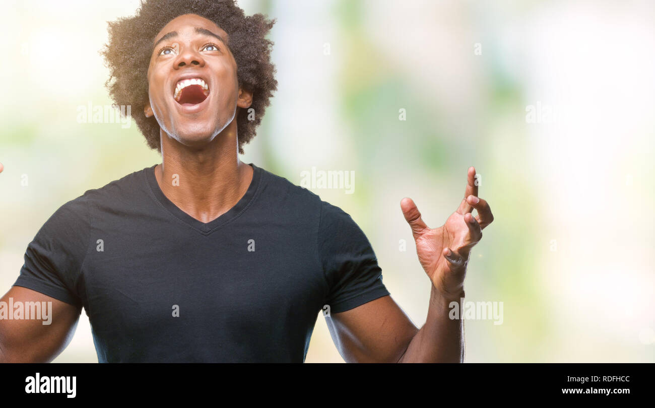 Afro american man over isolated background crazy and mad shouting and ...