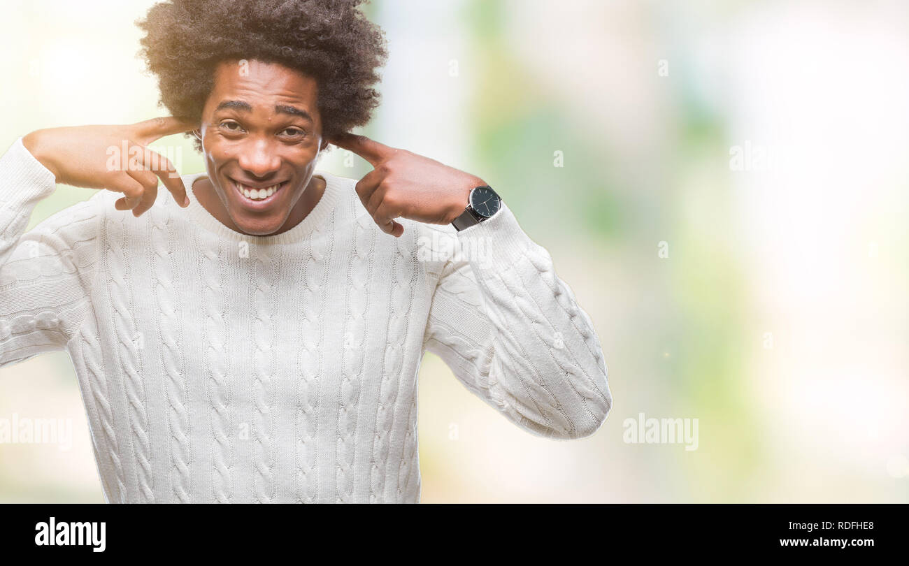 Afro american man over isolated background covering ears with fingers ...
