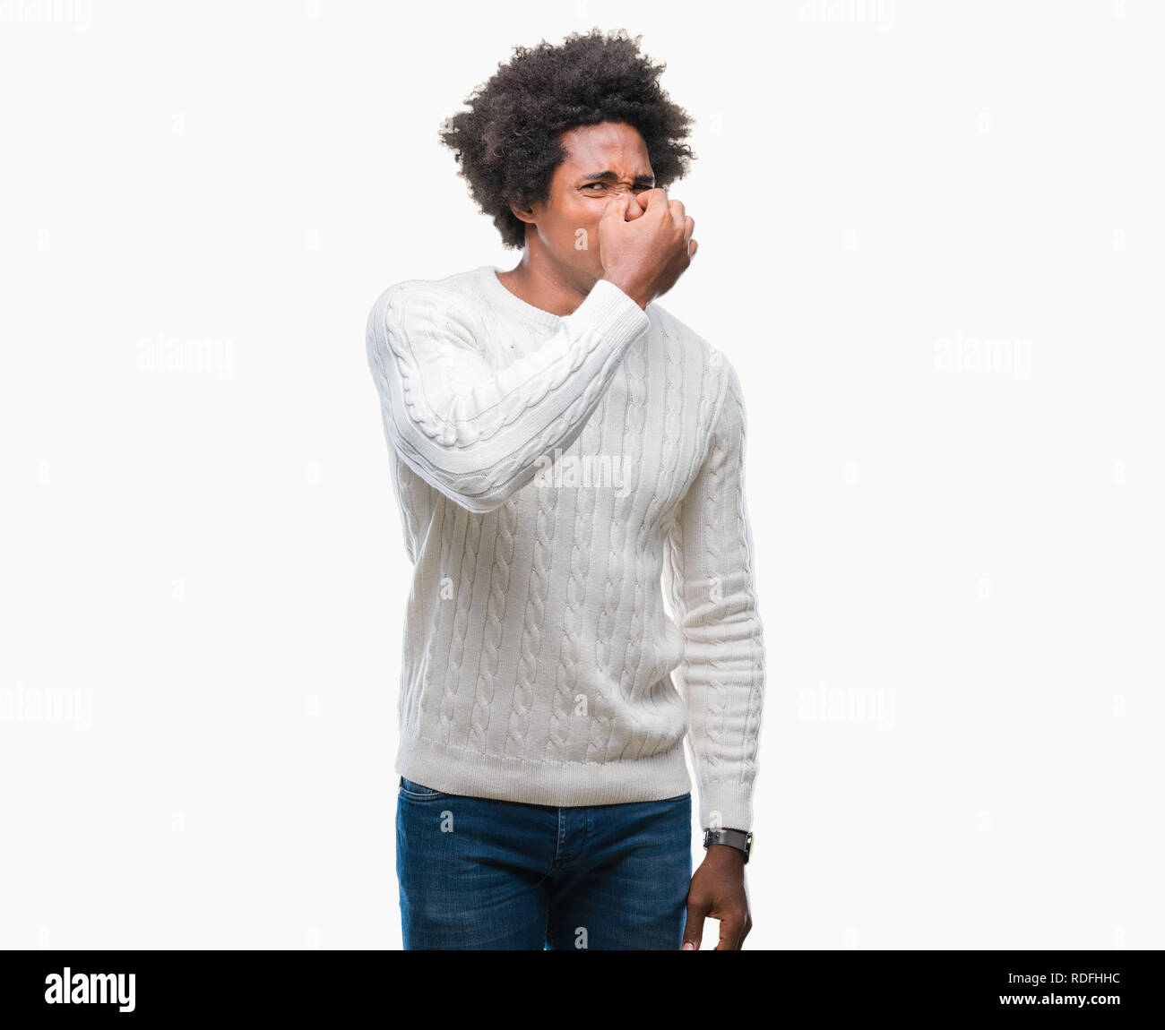 Afro american man over isolated background smelling something stinky ...