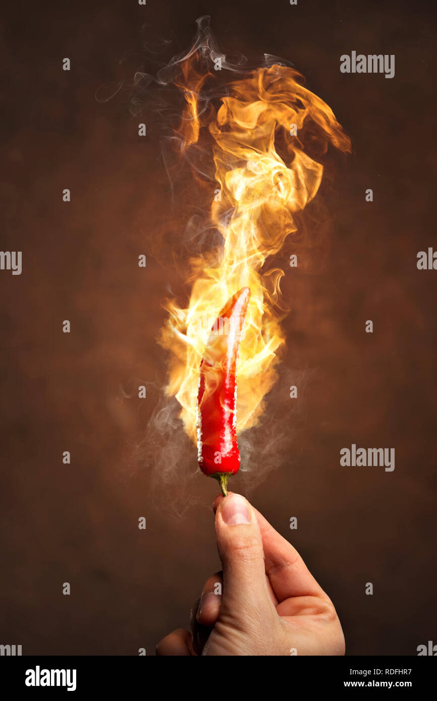 Hot chili pepper surrounded by fire and flames Stock Photo - Alamy