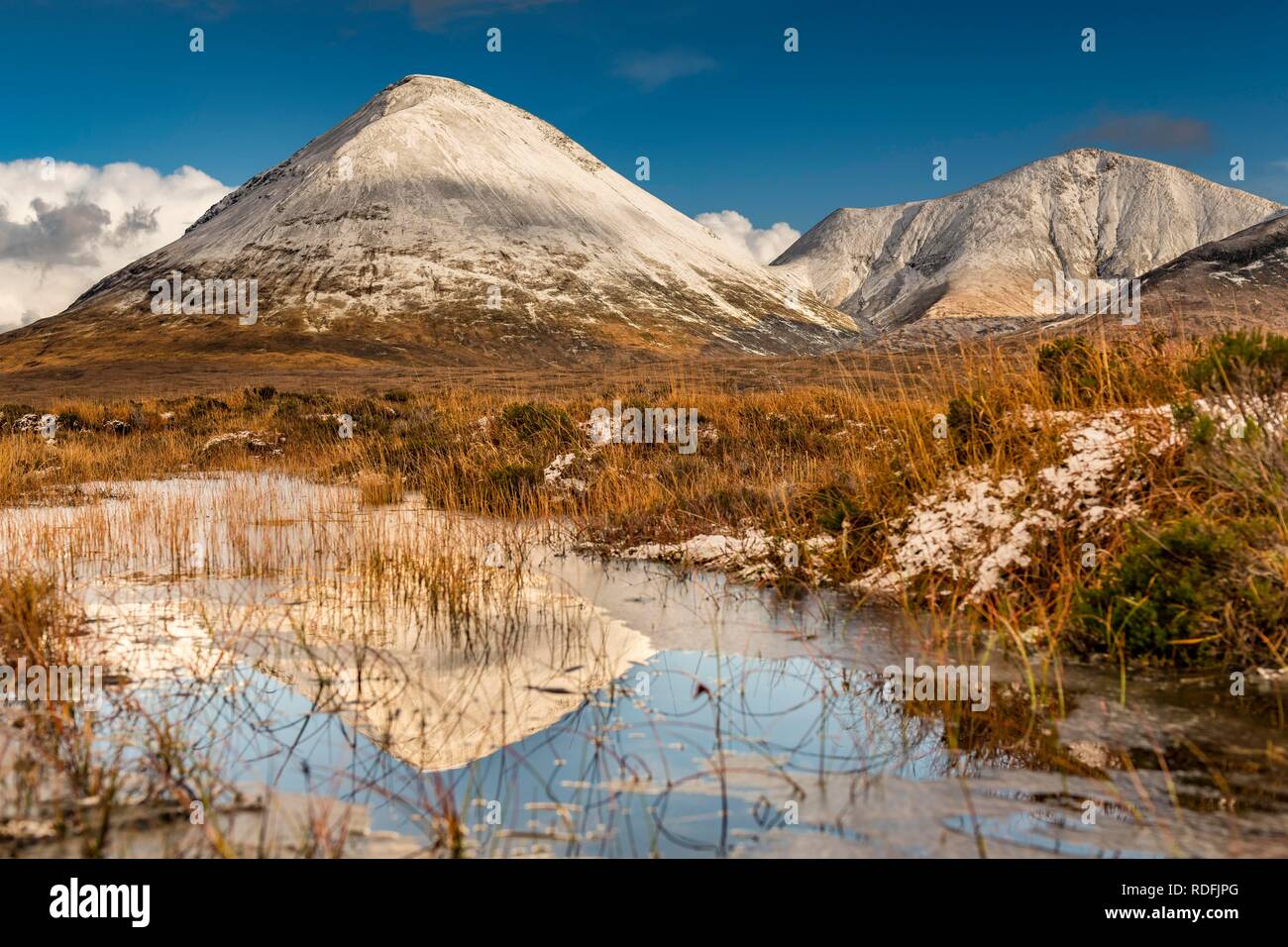 Moor landscape with snow-covered peaks of the Cullins Mountains in ...