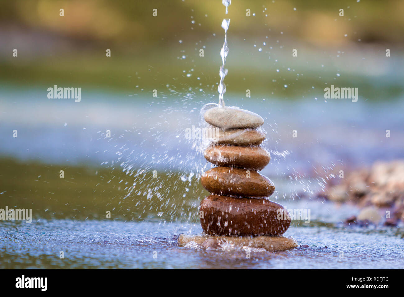 Close-up abstract image of water pouring down on rough natural brown ...