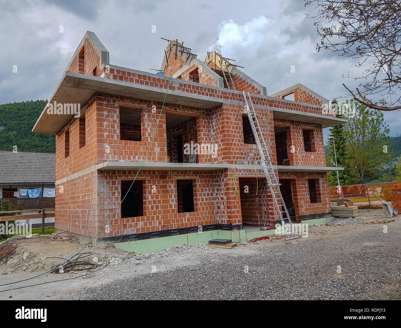 brick house almost ready for roof Stock Photo - Alamy