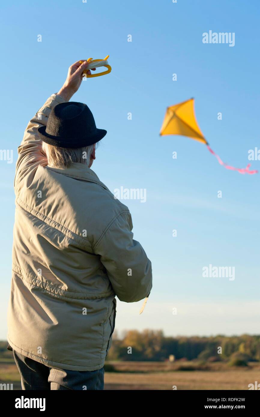Elderly man flying a kite Stock Photo - Alamy