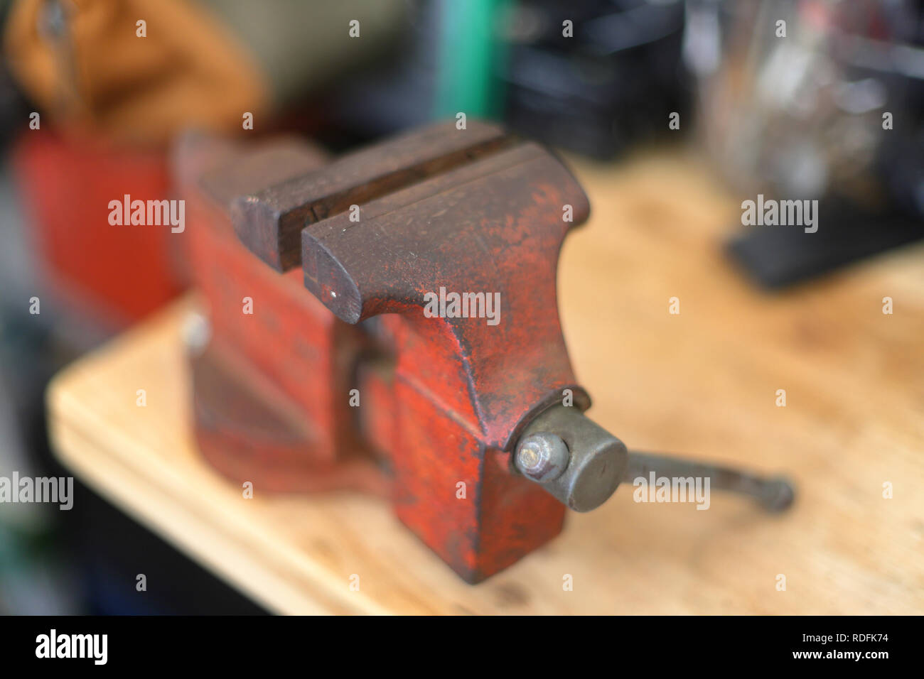 Vintage old red vise on wooden workbench with tools and hammer Stock ...