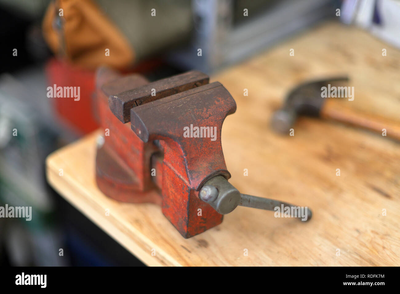 Vintage old red vise on wooden workbench with tools and hammer Stock ...