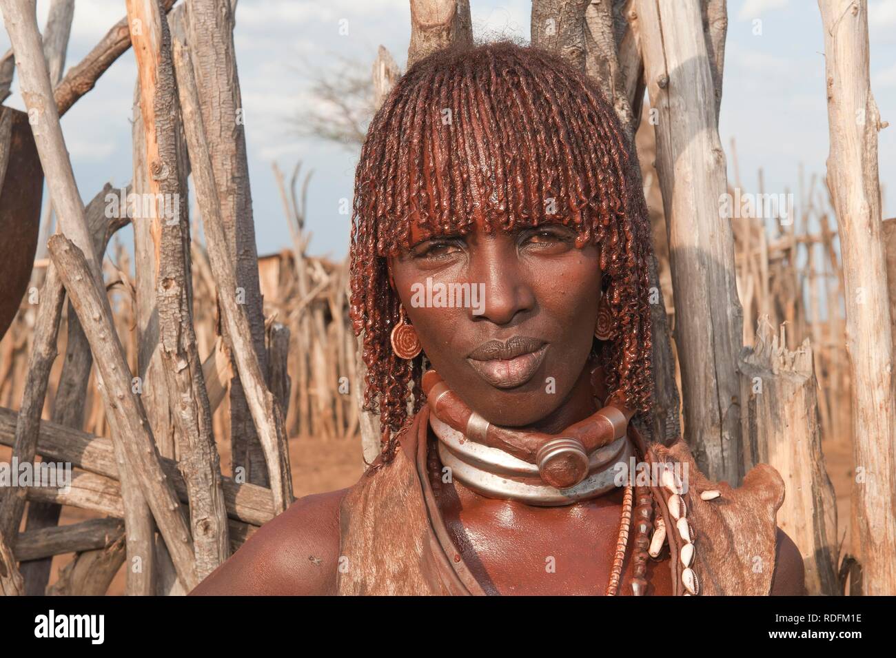 Young Hamar woman with traditional hairstyle with red clay in her hair ...