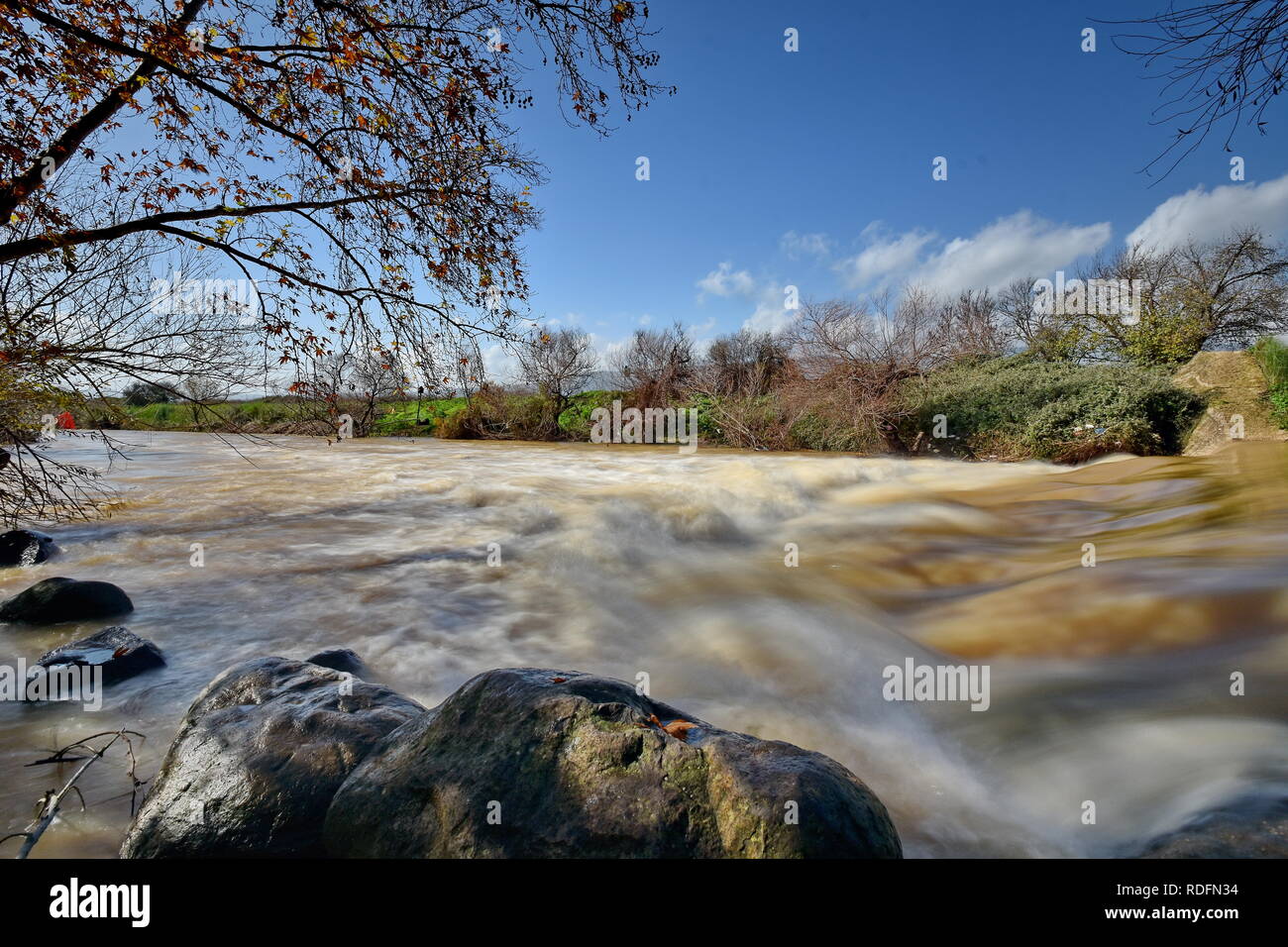 rapids in Jordan river in Israel with exposed rocks with long exposure ...