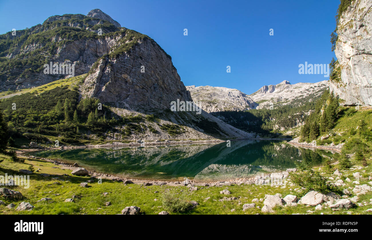 Krn lake with monument Krn behind it Stock Photo - Alamy