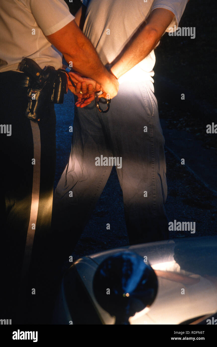 Policeman Arresting and Handcuffing a suspect, USA Stock Photo - Alamy