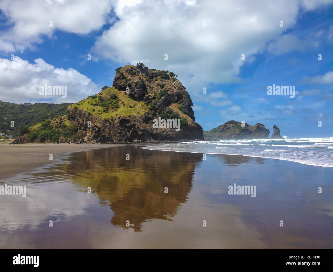 piha beach reflected in the sea with azure sky and clouds Stock Photo ...