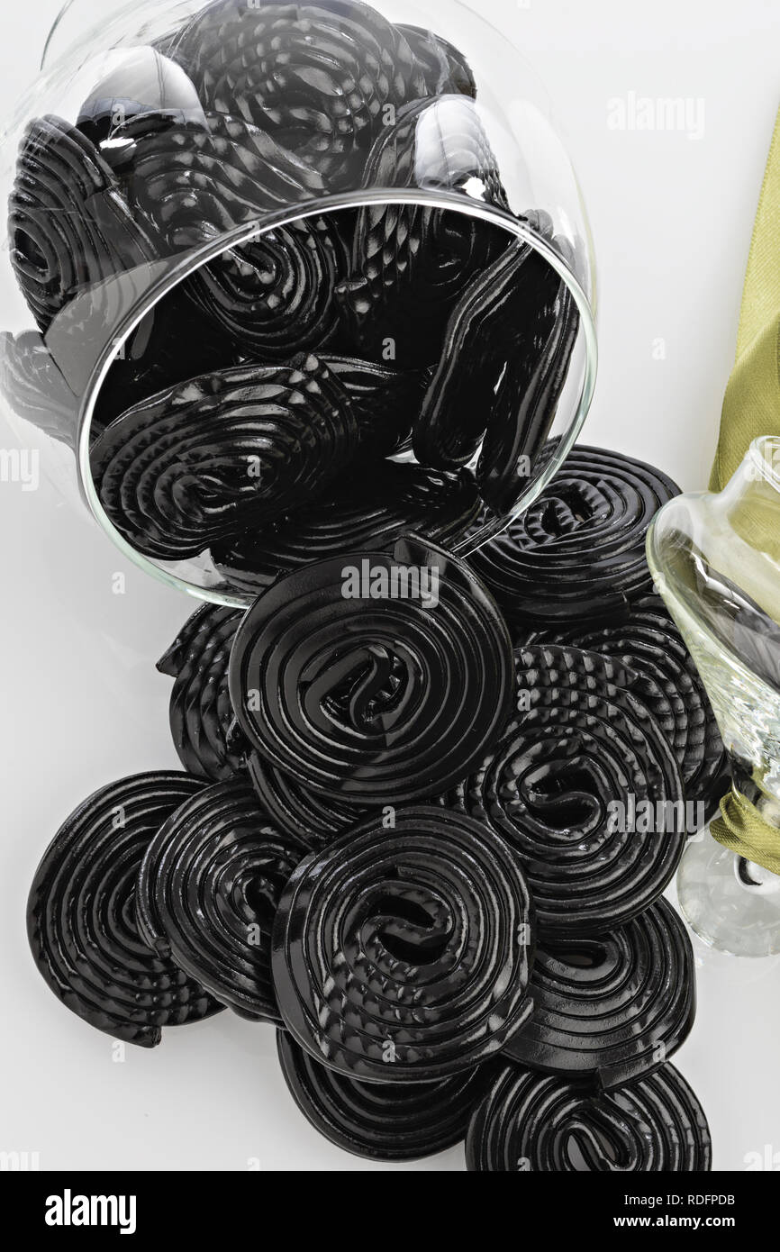 licorice wheels in inverted glass jar from above closeup Stock Photo ...