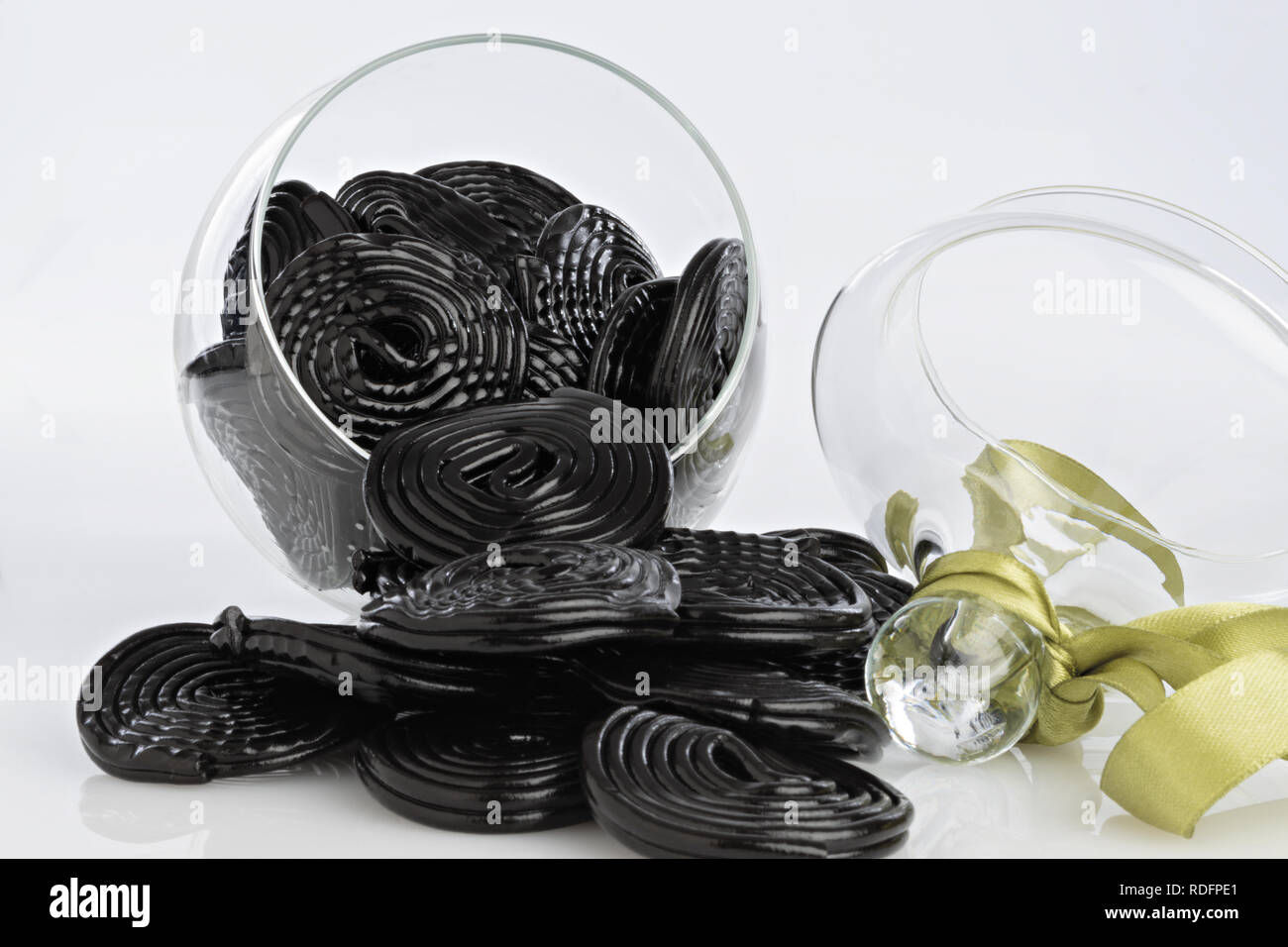 licorice wheels in inverted glass jar in front closeup Stock Photo - Alamy