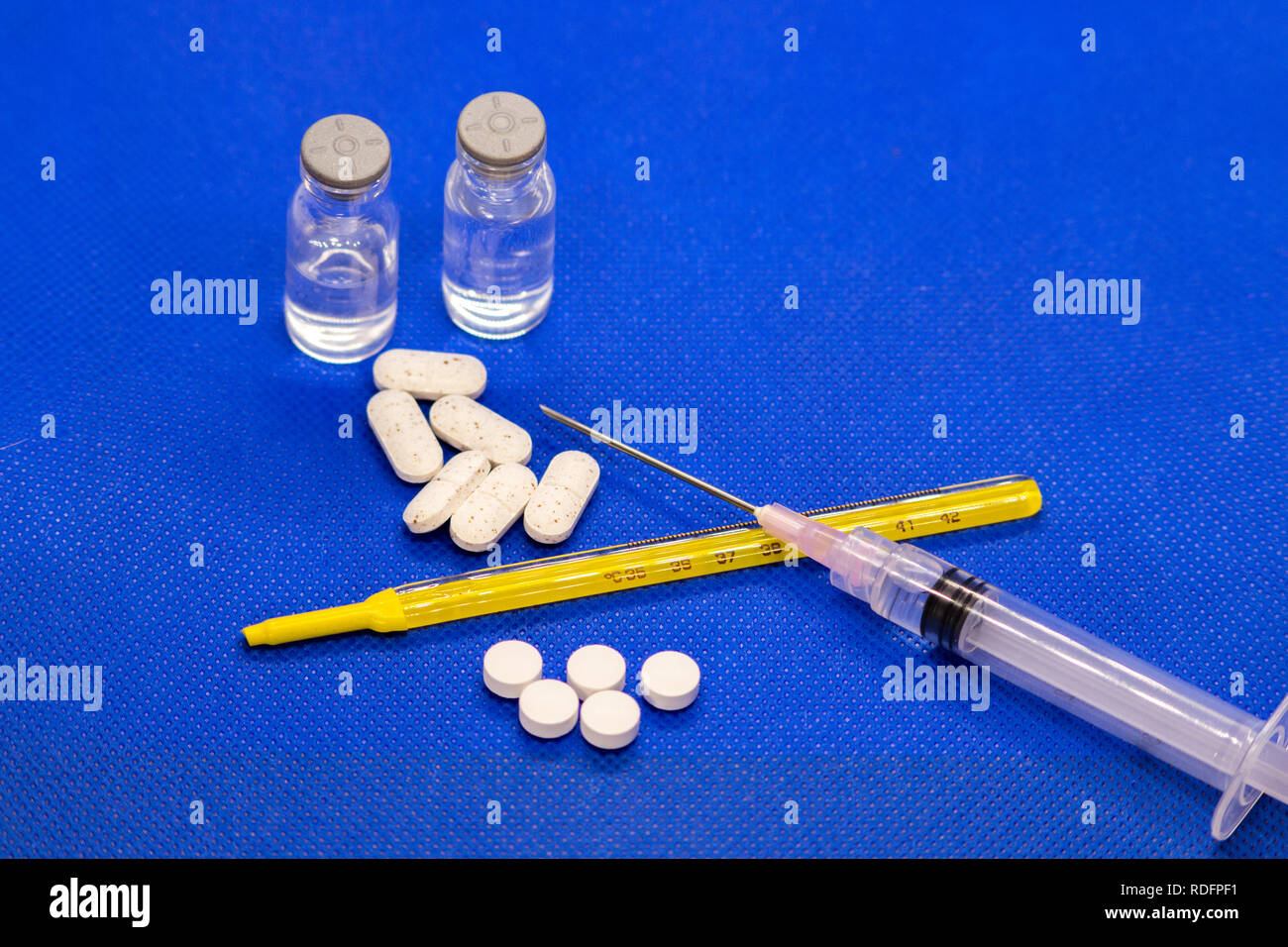 Set of cold medicine and flu virus on blue background. Antibiotics ...