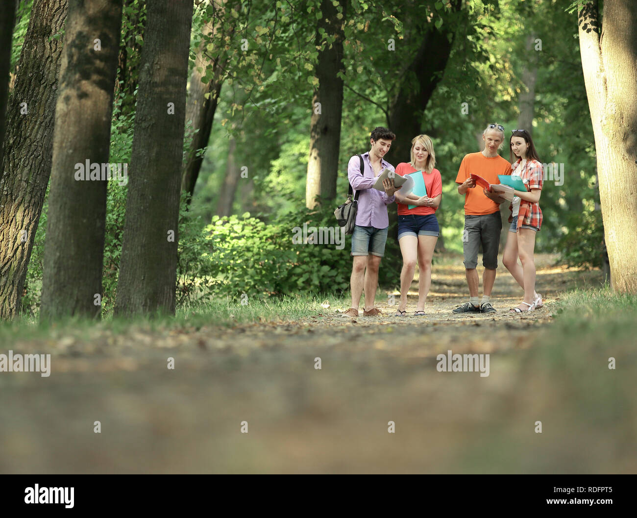 group of happy young students walking outdoors. Looking aside Stock ...