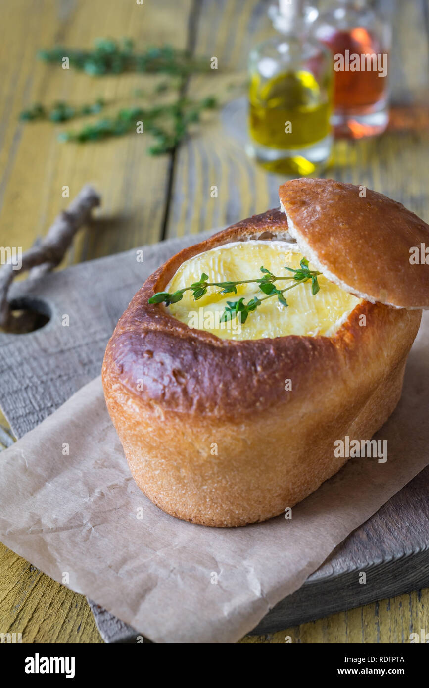 Camembert bread bowl decorated with fresh thyme Stock Photo - Alamy
