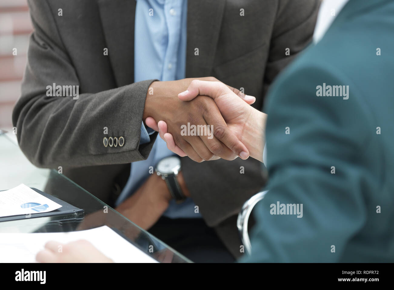 closeup.handshake trading partners on the background of the workplace ...