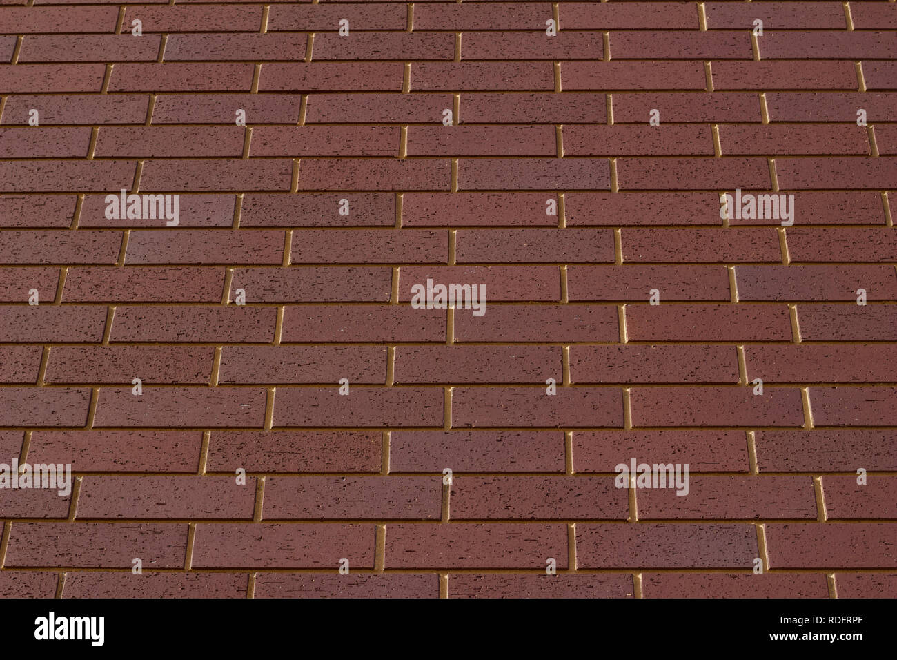 Reddish brown brick wall background with raking stretcher bond ...