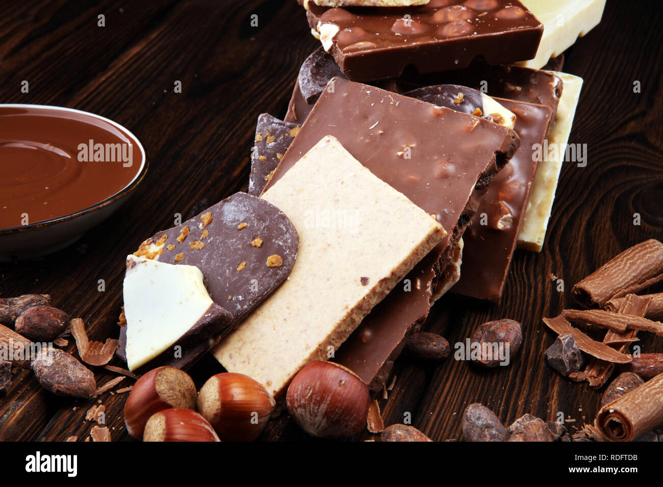 Chocolate bars on table with chocolate tower. Chocolate and nuts and ...