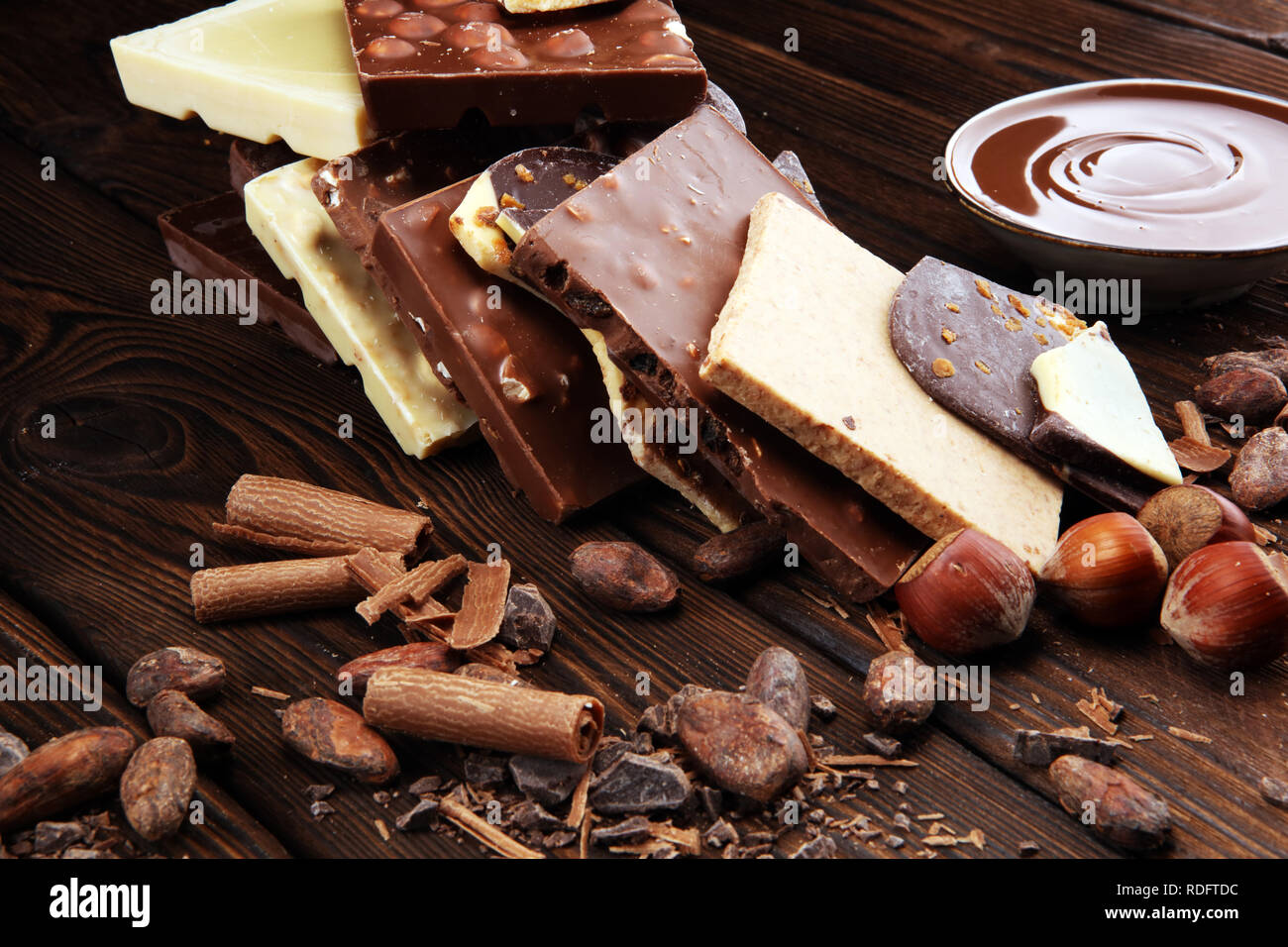Chocolate bars on table with chocolate tower. Chocolate and nuts and ...